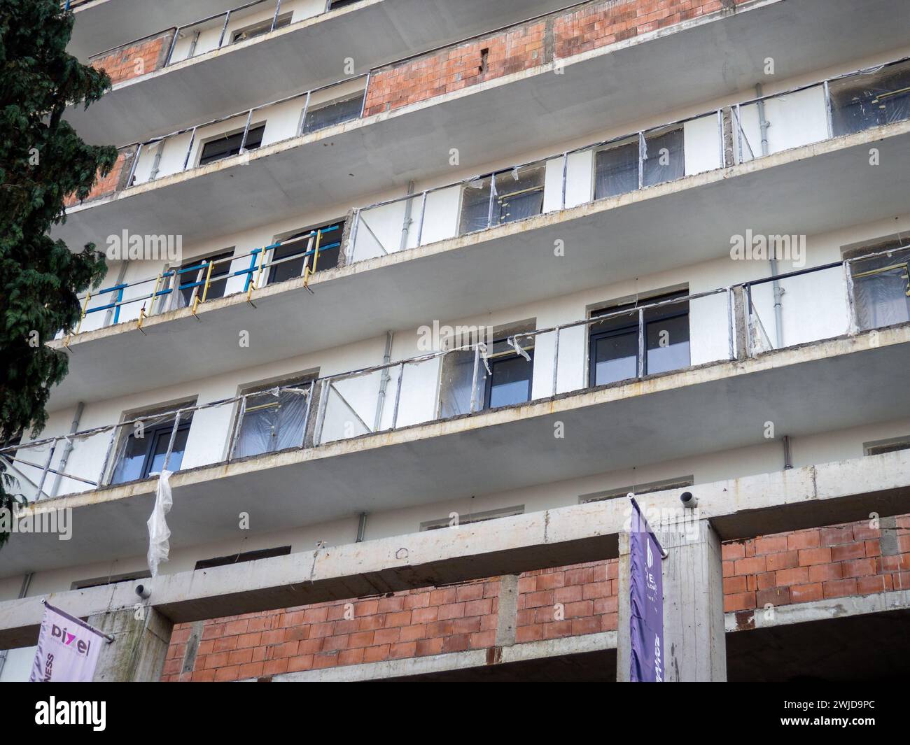 facade of an unfinished high-rise building. panel house. Balconies of a ...