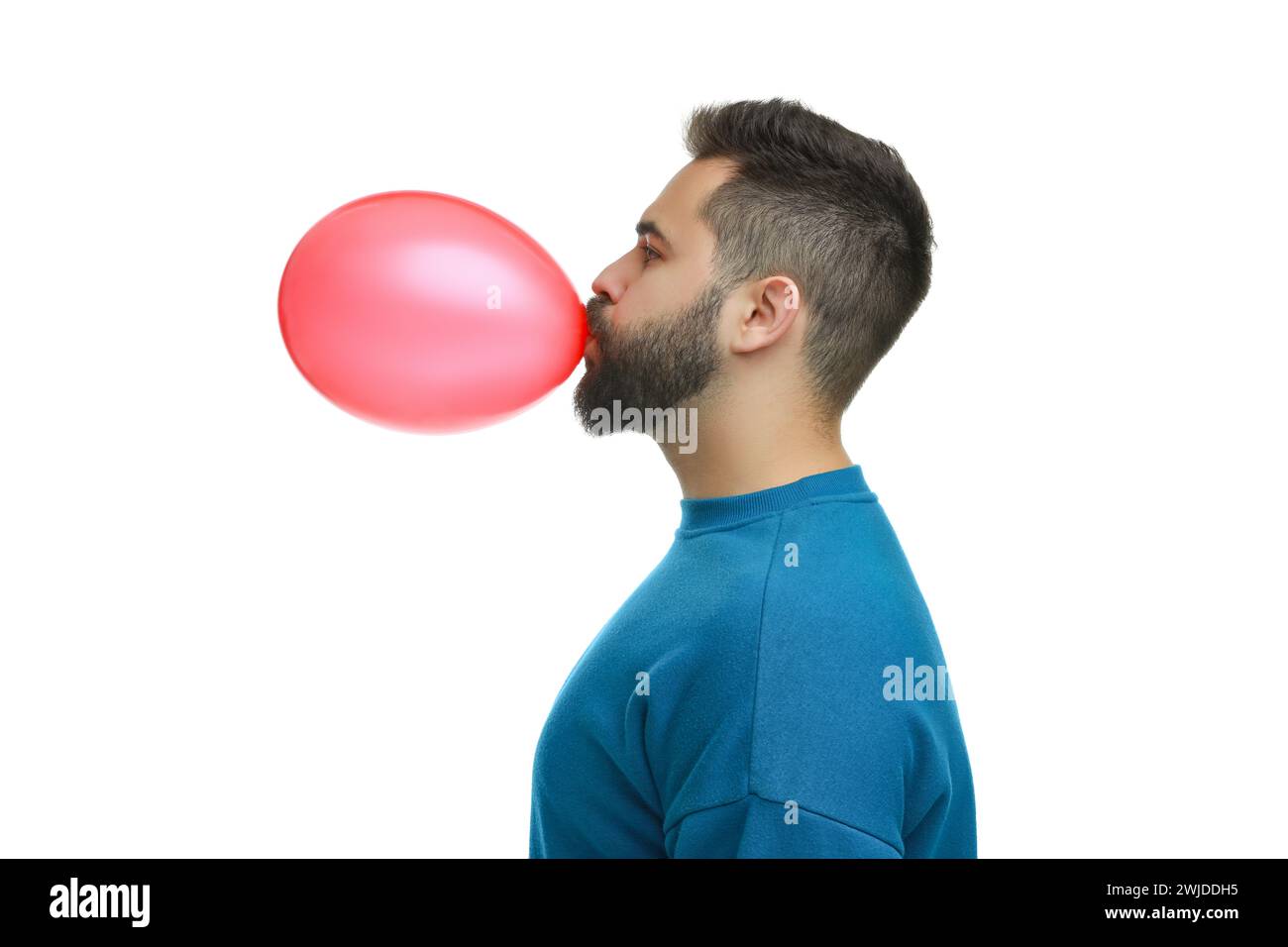 Man inflating bright balloon on white background Stock Photo - Alamy