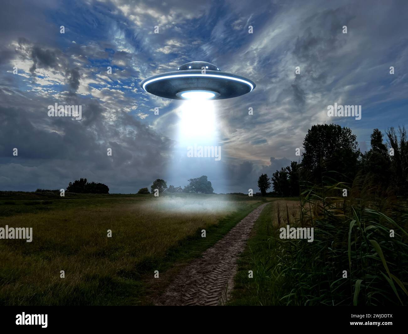 Alien spaceship emitting light beam in air over countryside. UFO Stock ...