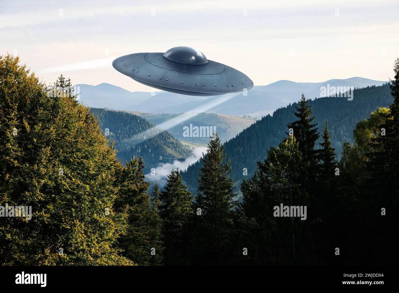 Alien spaceship flying over trees in mountains. UFO Stock Photo - Alamy