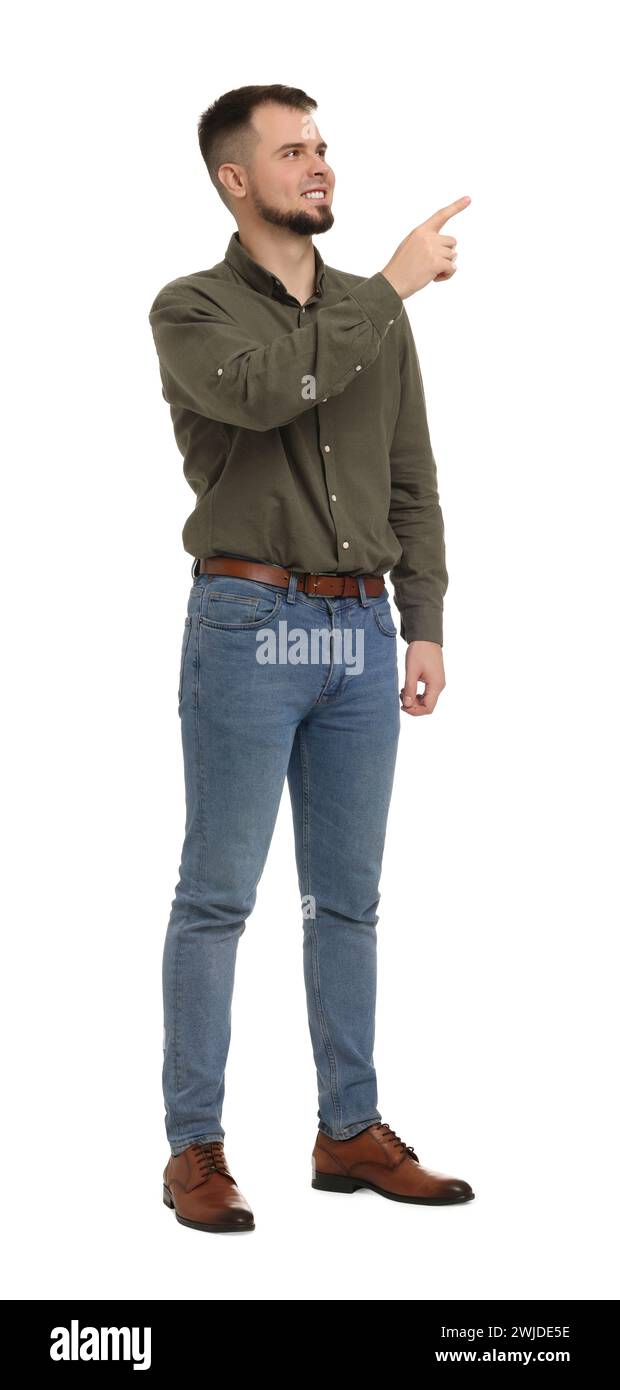 Man in shirt and jeans pointing at something on white background Stock ...