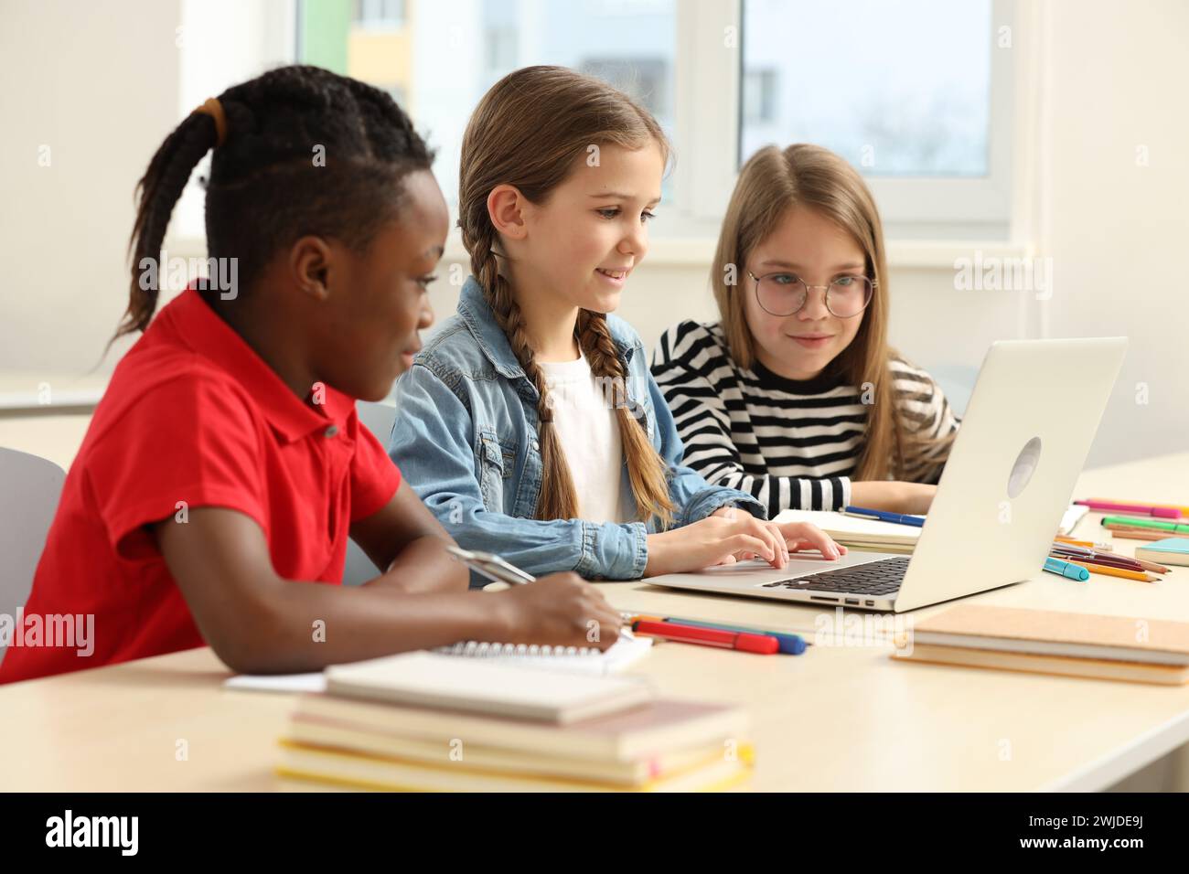 Cute children studying in classroom at school Stock Photo - Alamy