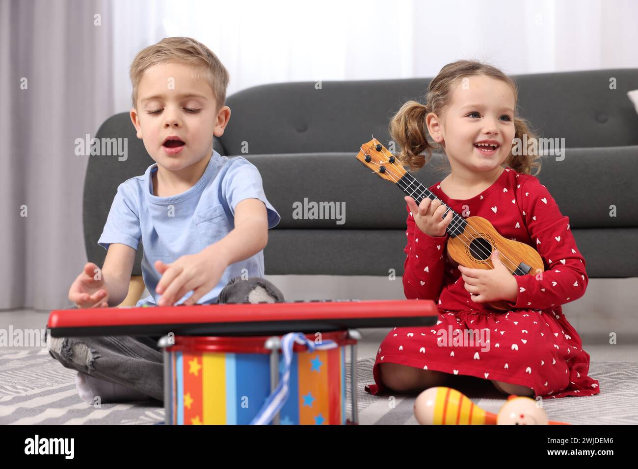 Little children playing toy musical instruments at home Stock Photo - Alamy