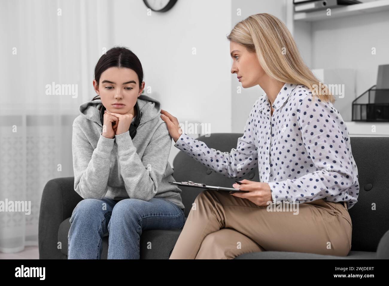 Psychologist working with teenage girl in office Stock Photo - Alamy