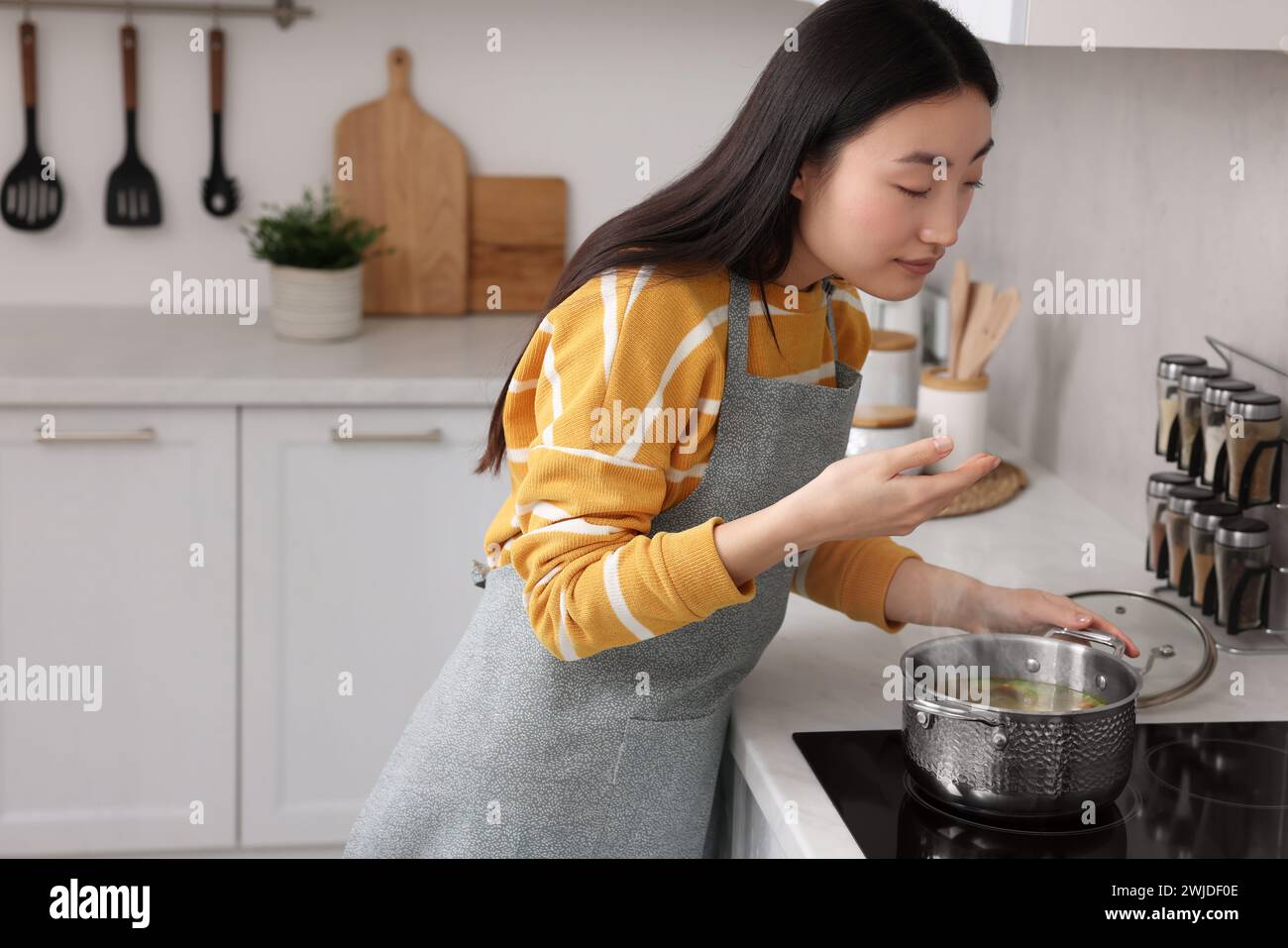 Woman cooking soup beautiful hi-res stock photography and images - Alamy
