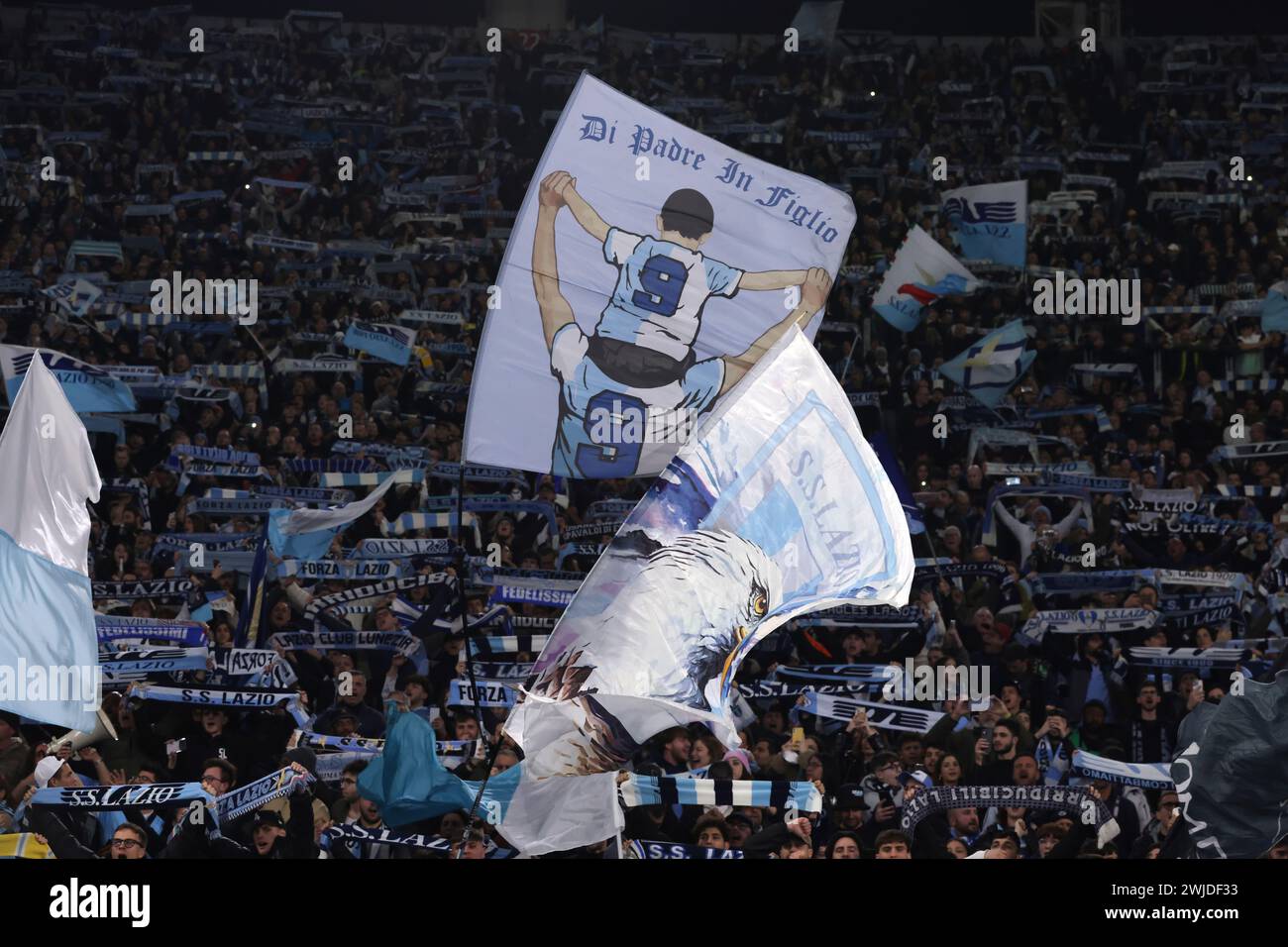 Rome, Italy, 14th February 2024. SS Lazio fans wave flags and cheer on ...