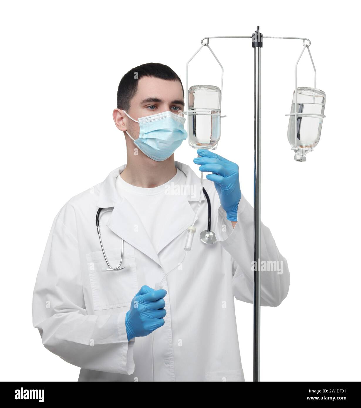 Doctor setting up IV drip on white background Stock Photo - Alamy