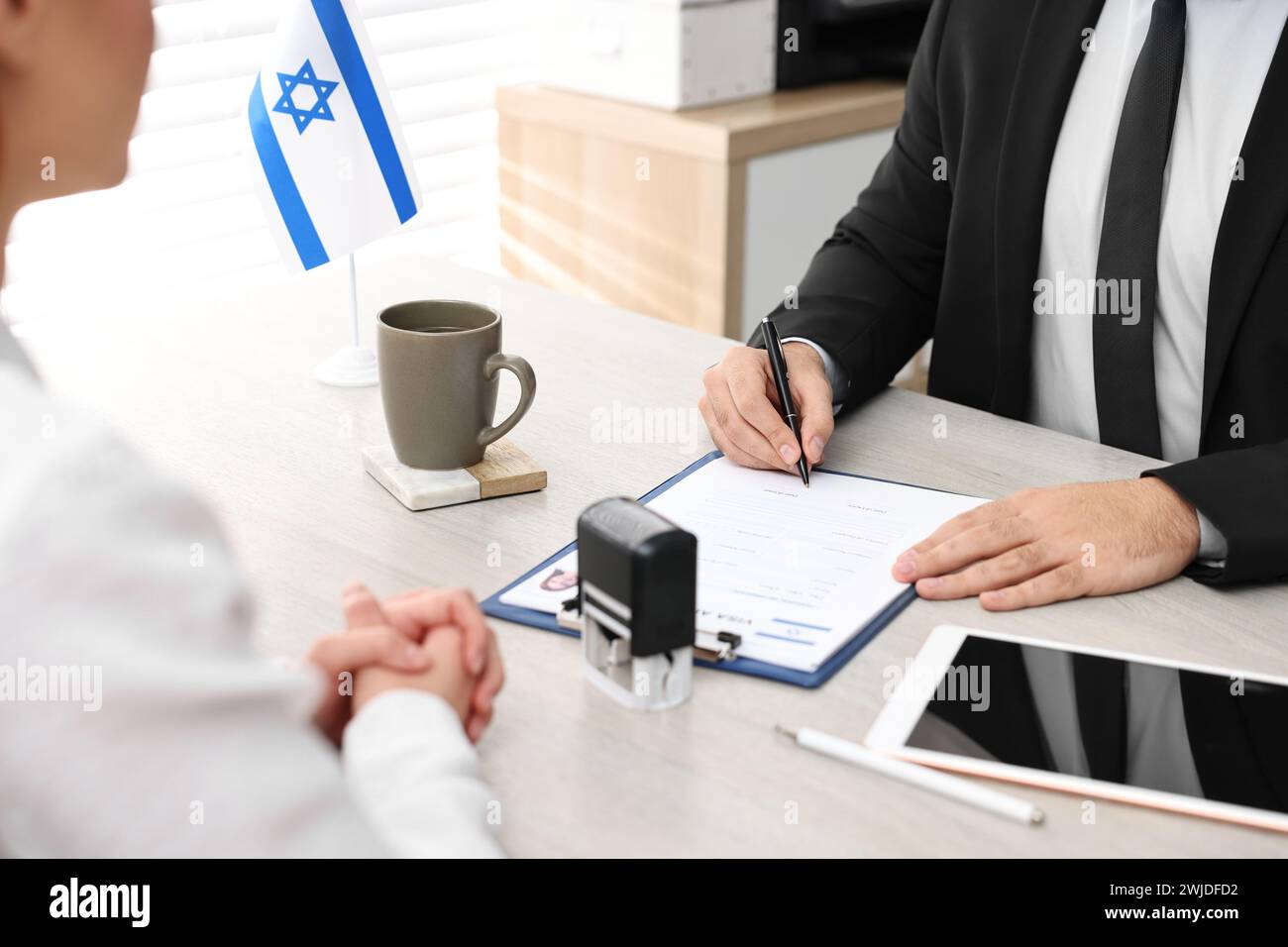 Immigration to Israel. Embassy worker signing application form at ...