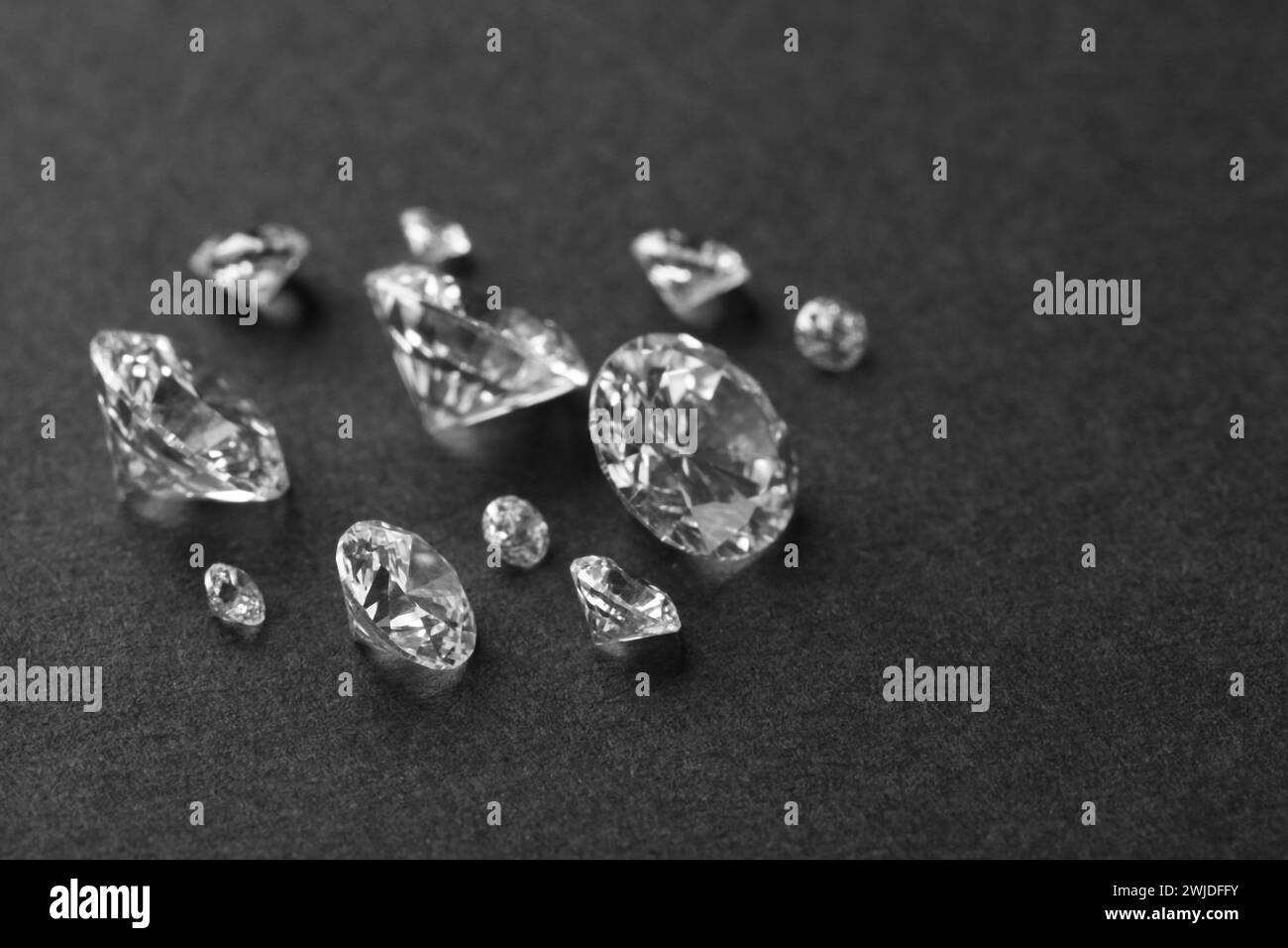 Beautiful shiny diamonds on gray table, closeup. Space for text Stock ...