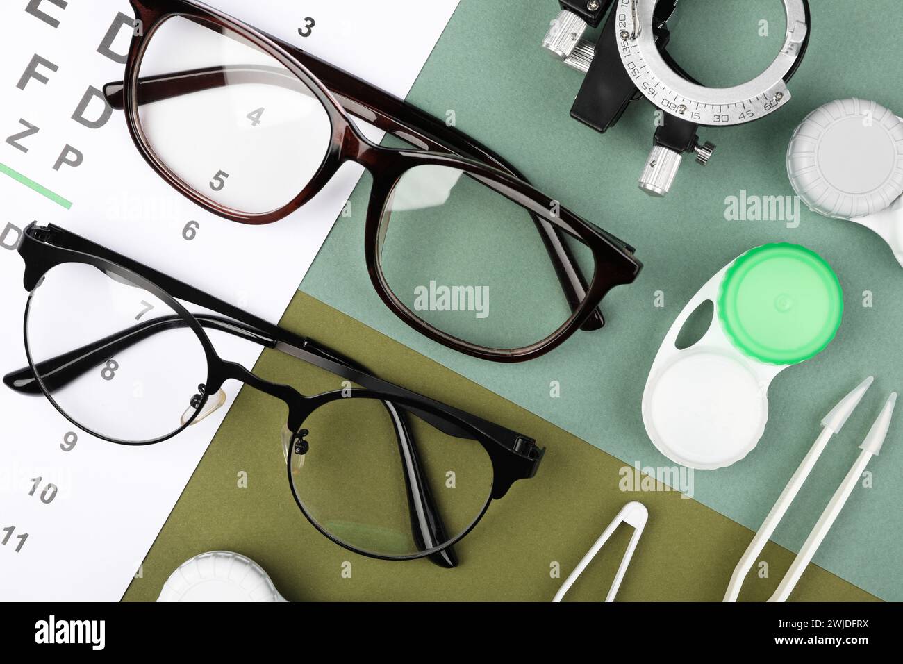 Flat lay composition with vision test chart and glasses on color ...