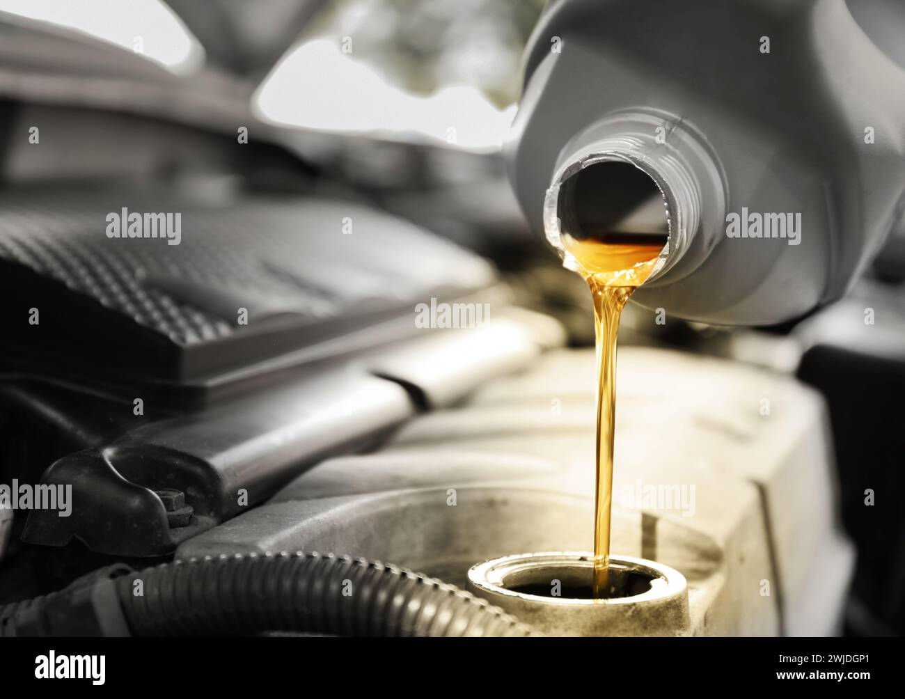 Pouring motor oil into car engine, closeup. Color accent effect Stock ...