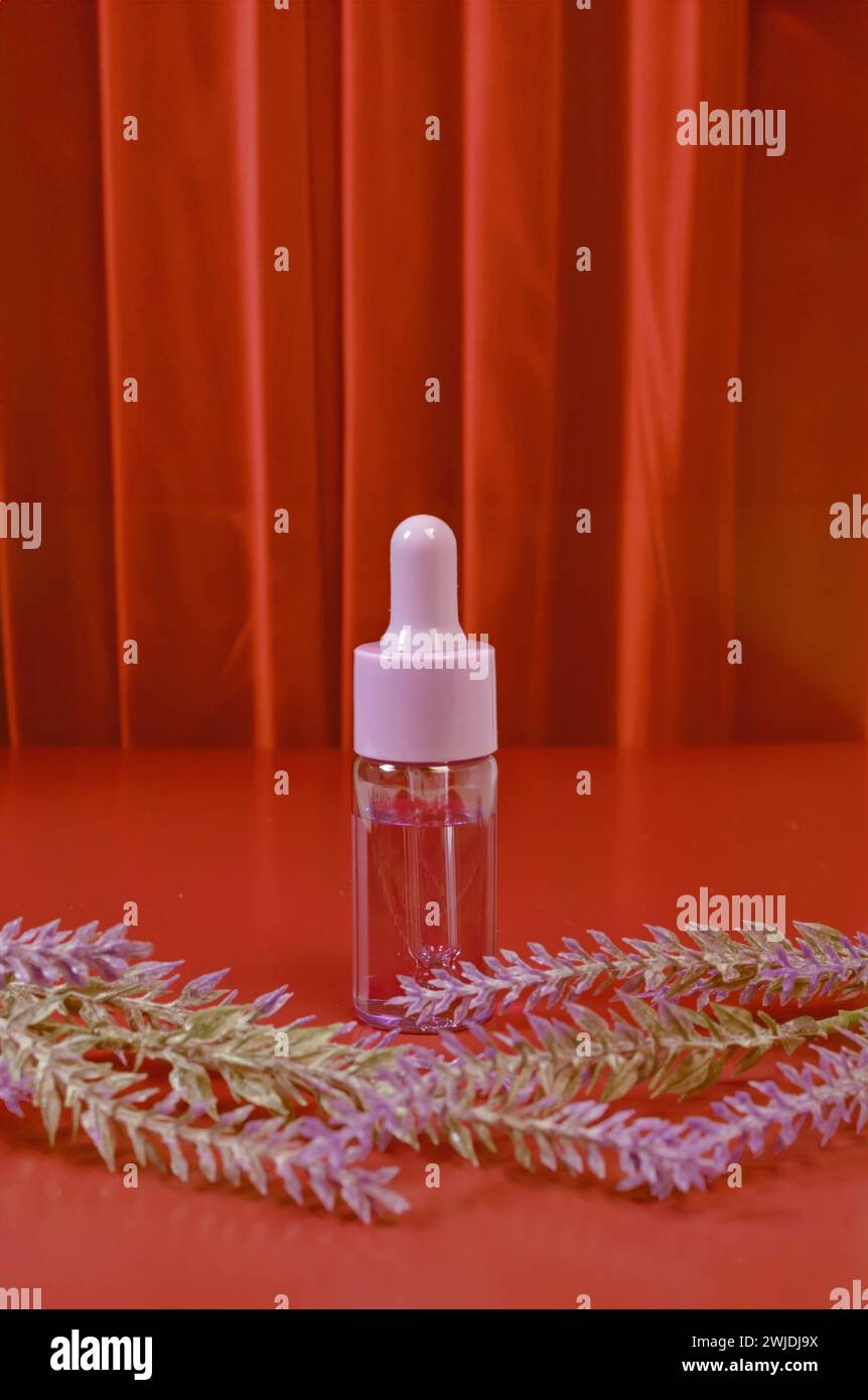 A Single Beauty Serum Oil Bottle with Lavender on a Orange Curtain ...