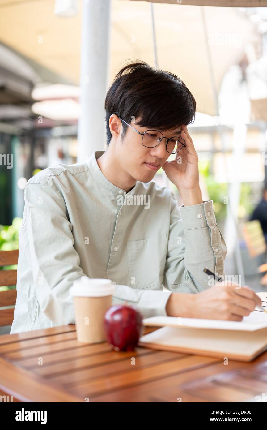 Serious asian businessman working paper hi-res stock photography and ...