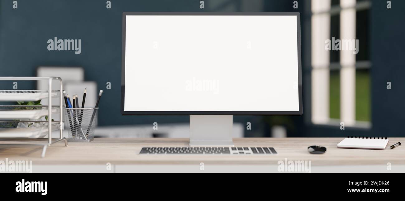 A white-screen computer mockup and office supplies on a wooden desk in ...
