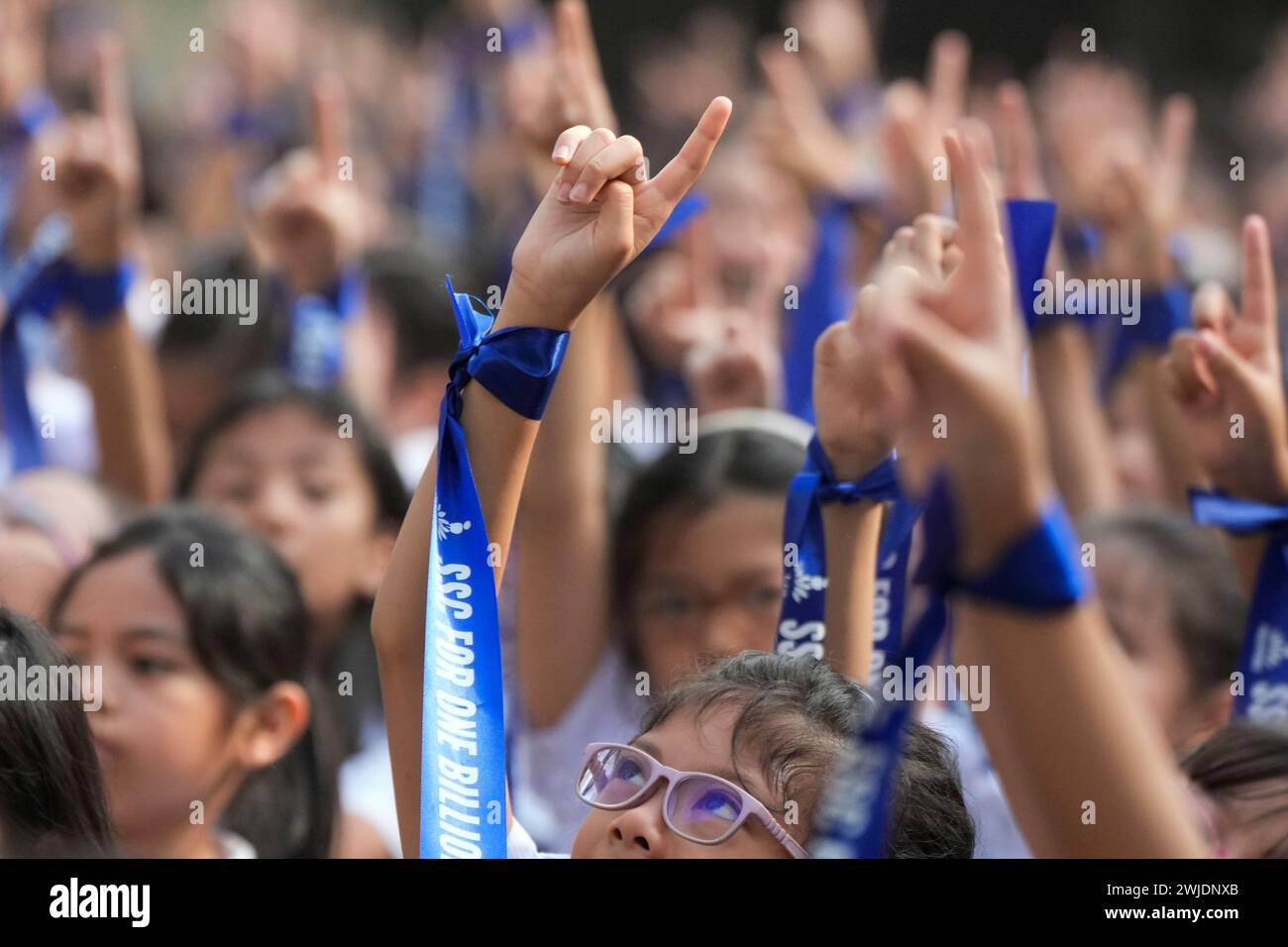 Students at Catholic-run St. Scholastica's College flash the number 1 ...