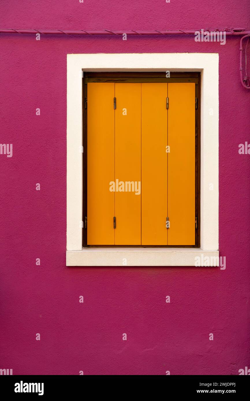 Front view of a Venetian building facade windows with wooden shutters ...