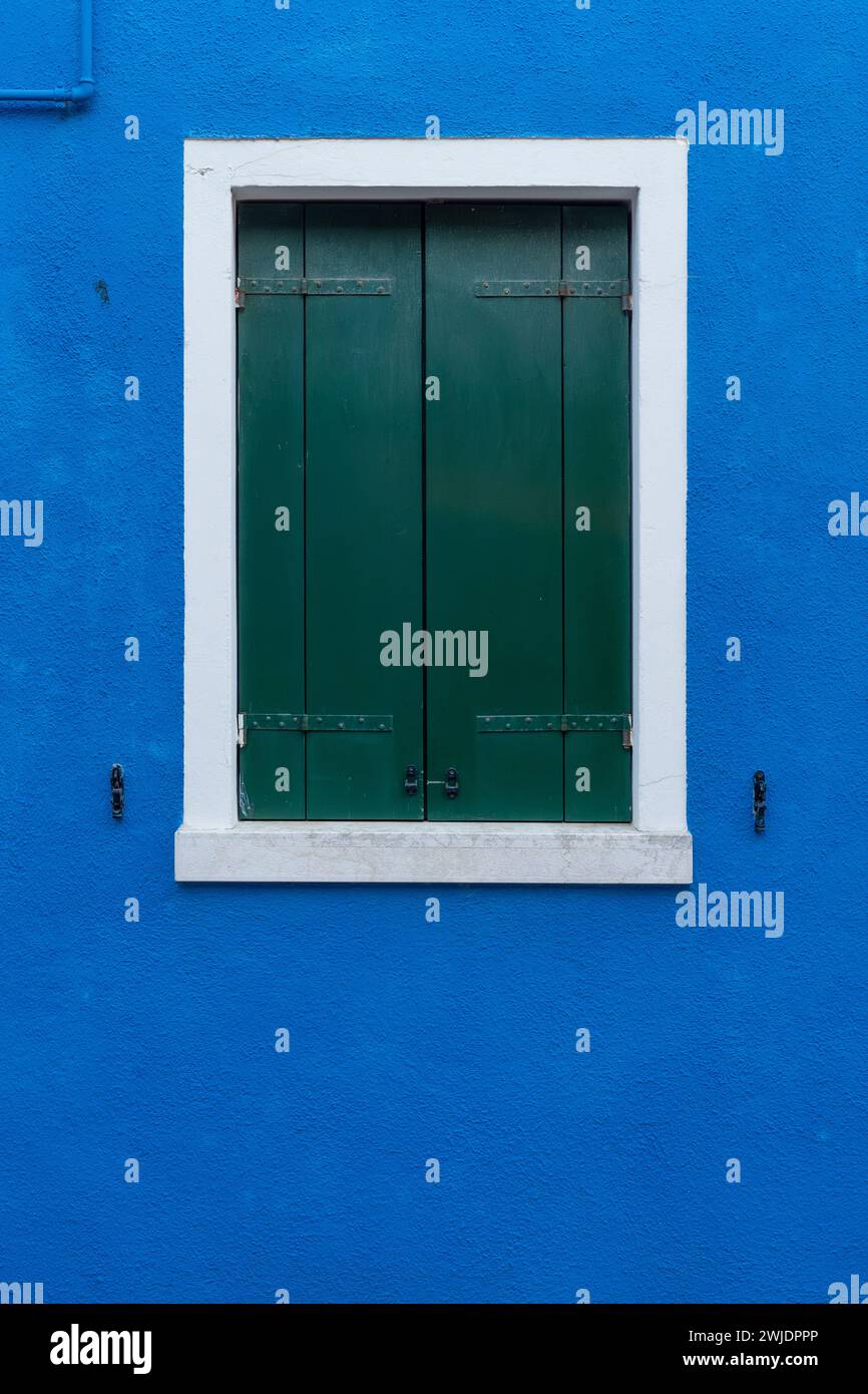 Front view of a Venetian building facade windows with wooden shutters ...