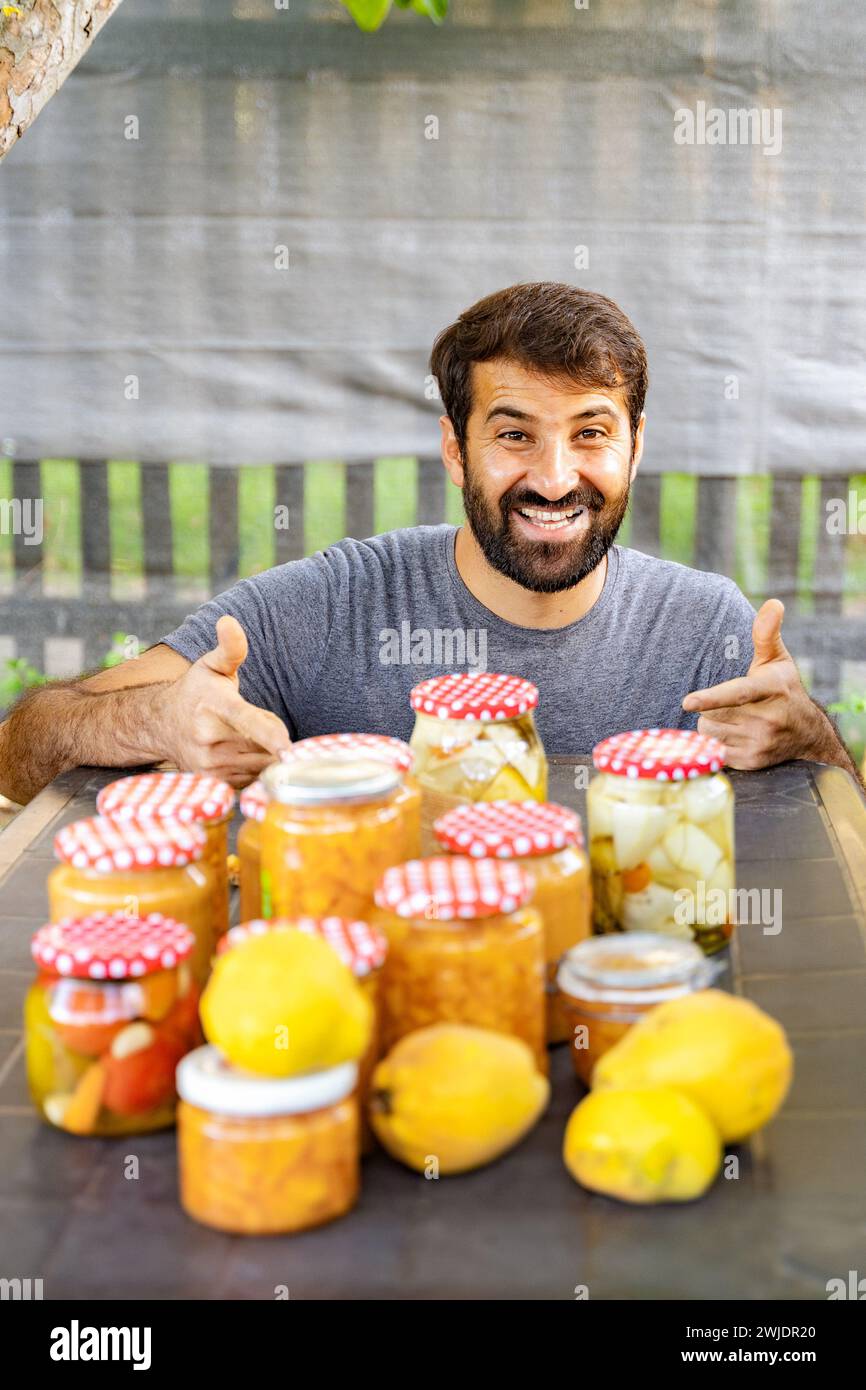 Happy man at table with natural foods and lemons, giving thumbs up ...