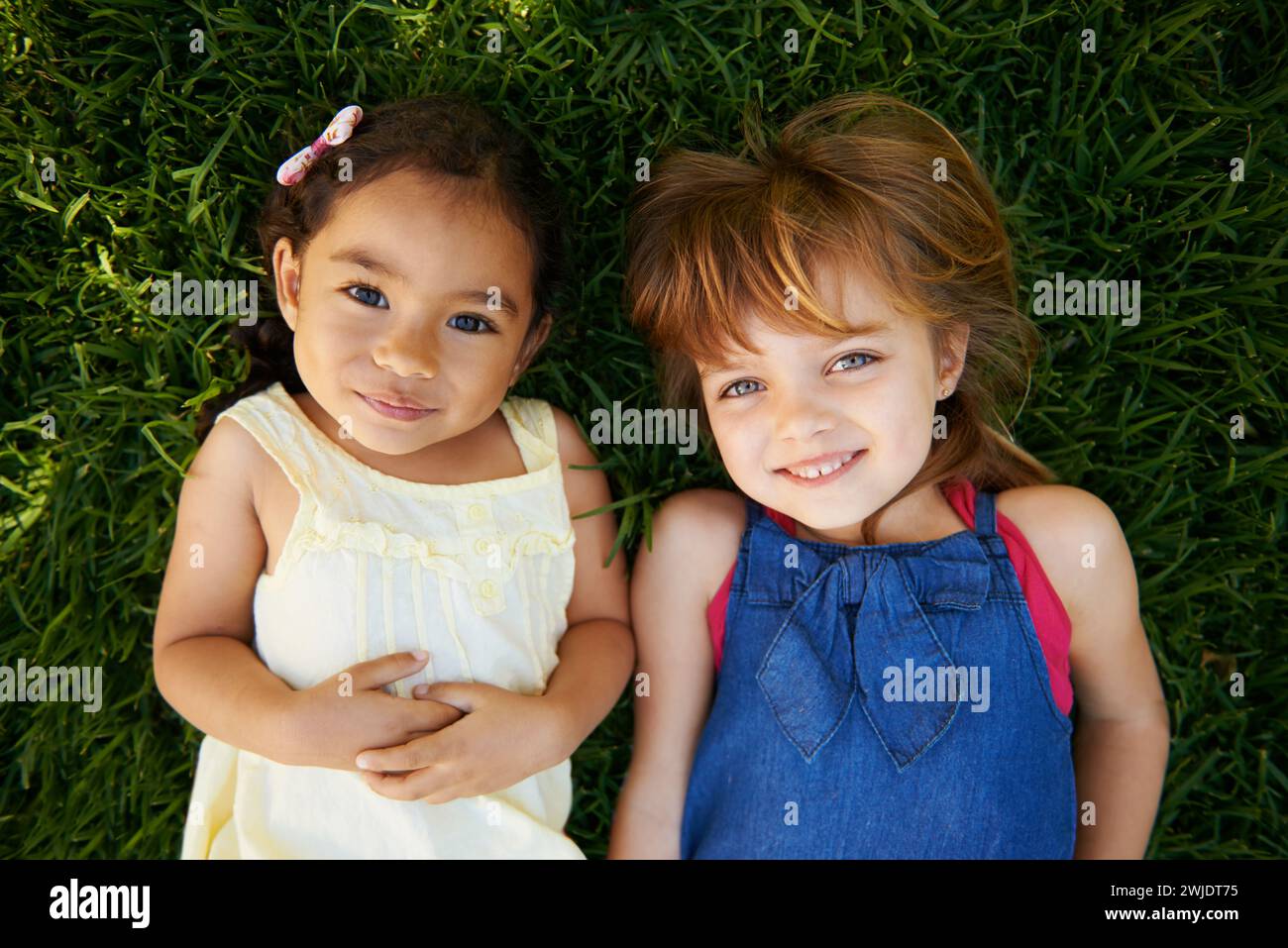 Happy, nature and girl children on grass play together in outdoor park ...