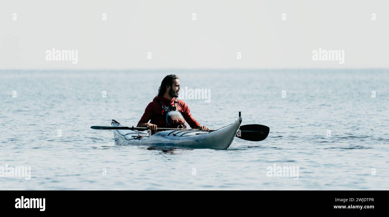 Man sea kayak. Happy free man in kayak on ocean, paddling with carbon ...