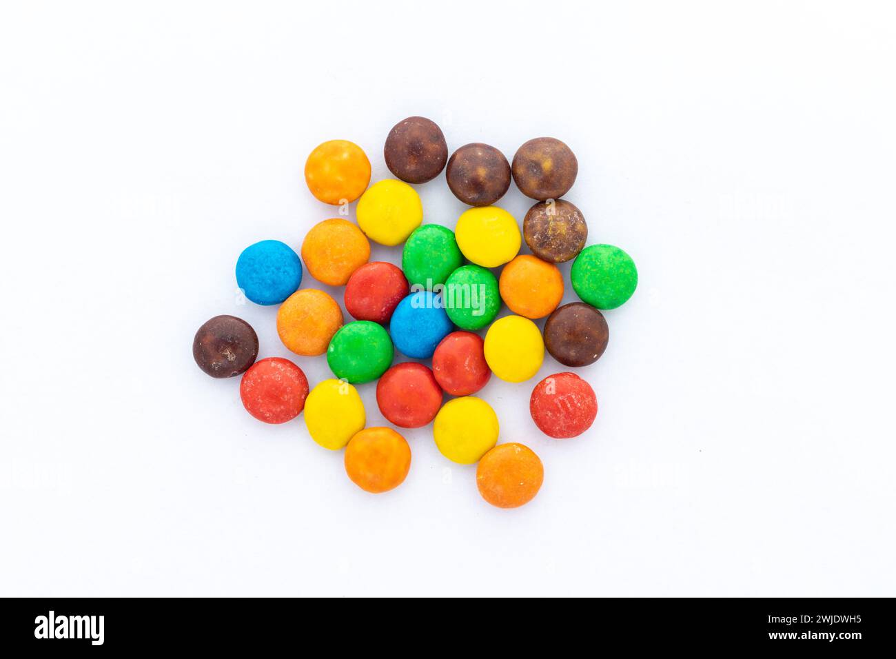 Multicolor delicious chocolate button candies on white isolated ...