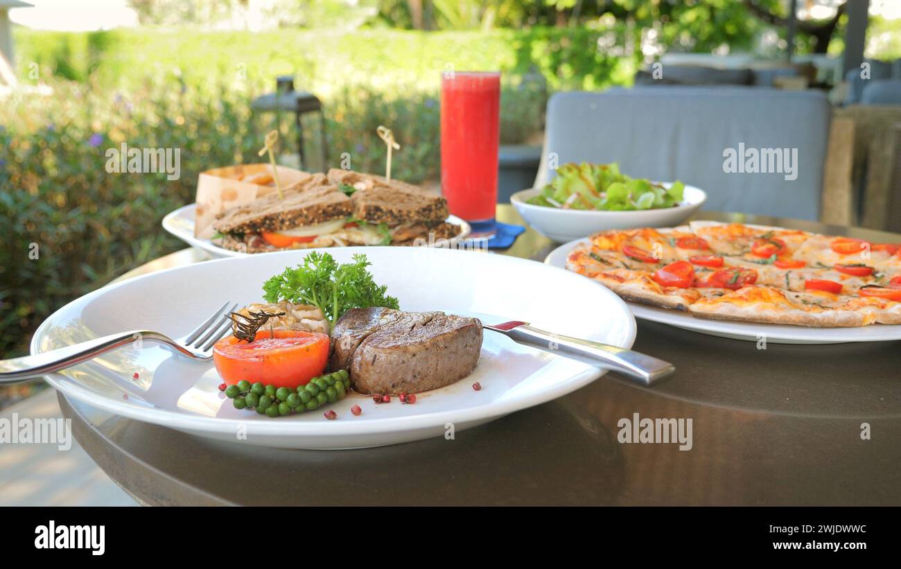 Gourmet outdoor dining experience with variety of dishes Stock Photo ...