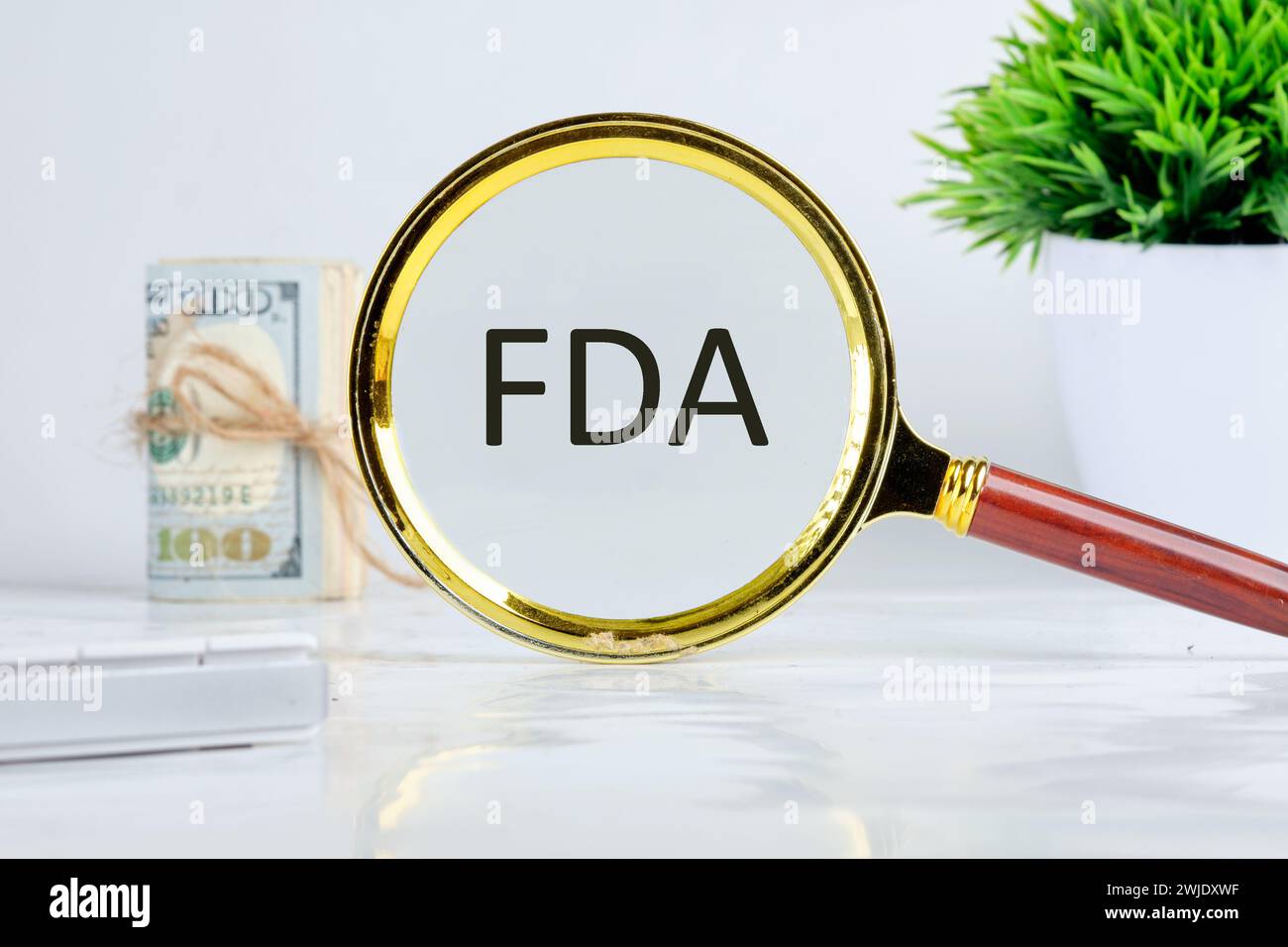 Word FDA written through a magnifying glass on a light background near ...