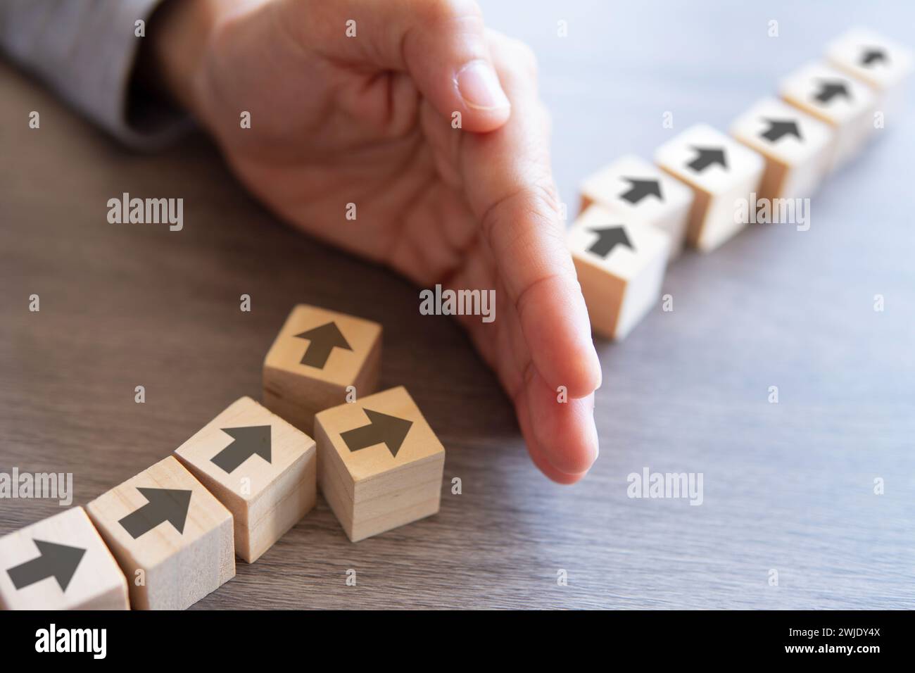 Wooden blocks with arrow and hand. Delays and disruptions, stop the ...