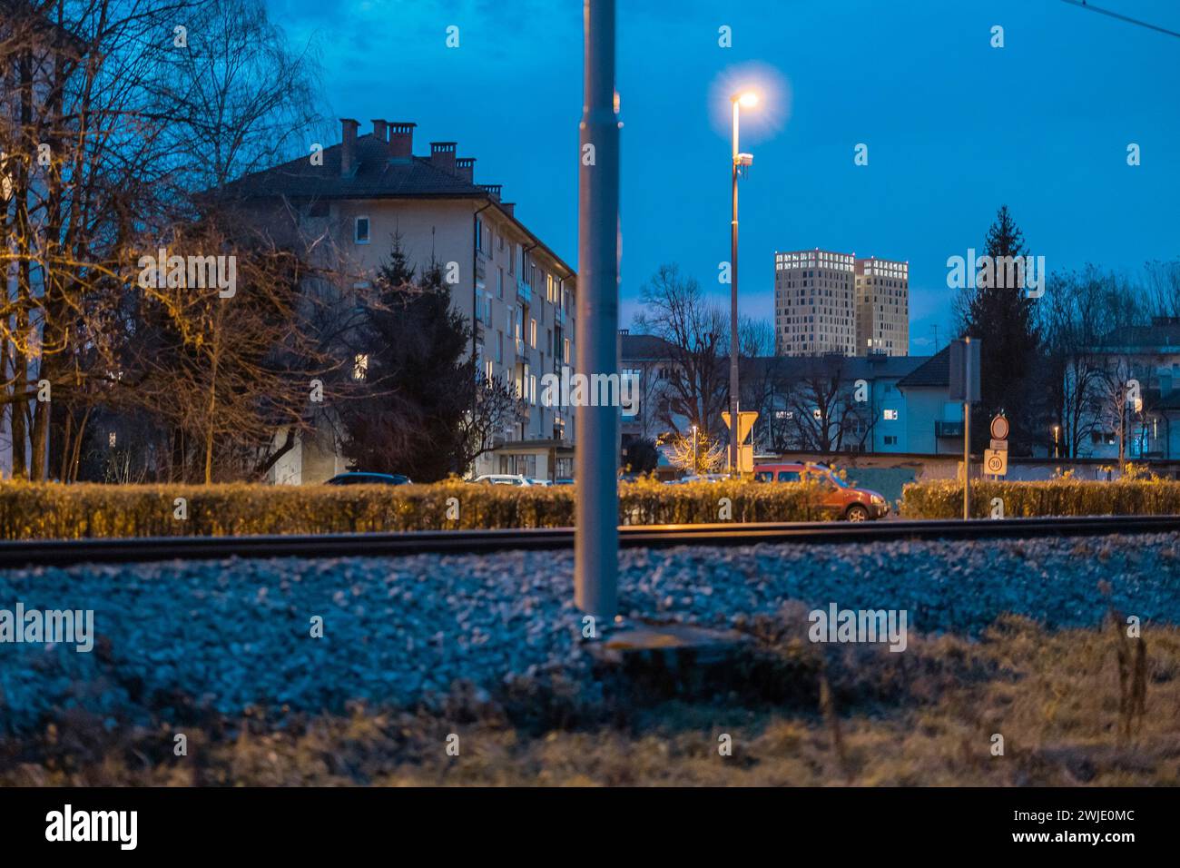Modern golden skyscraper rising up from the older houses from suburbs ...