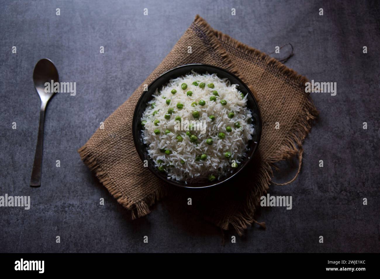 Green peas pulao made from Basmati rice served in a bowl. View from top ...