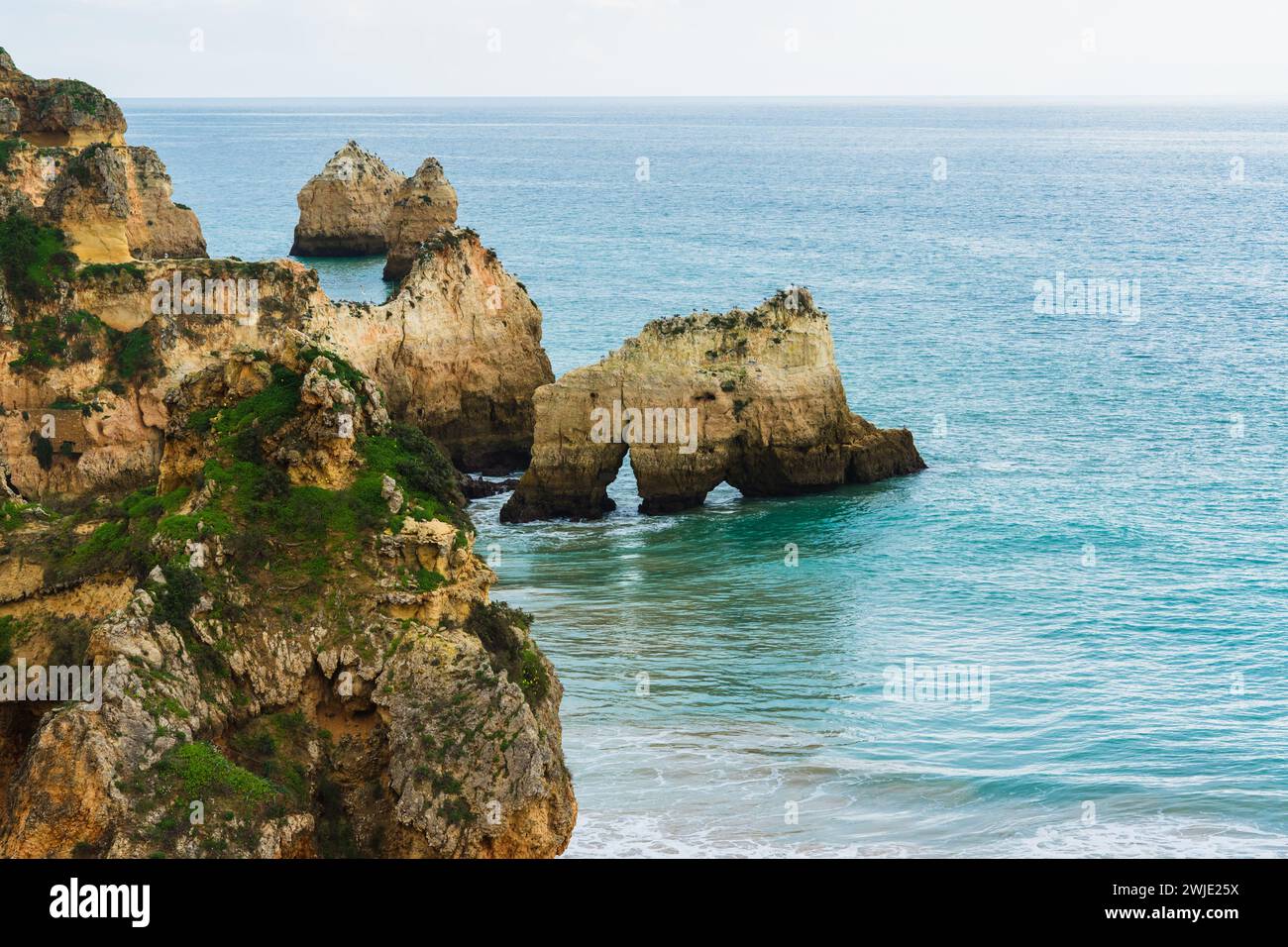 Breathtaking coastal scene with rugged cliffs, natural arches, and ...