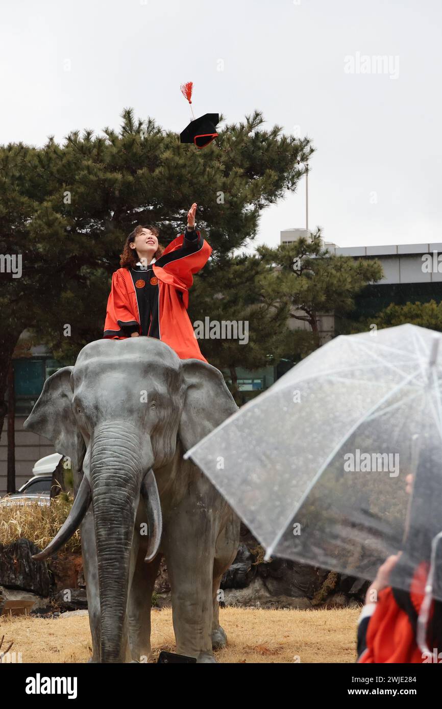 15th Feb, 2024. Graduation ceremony A graduate poses for a photo on an ...