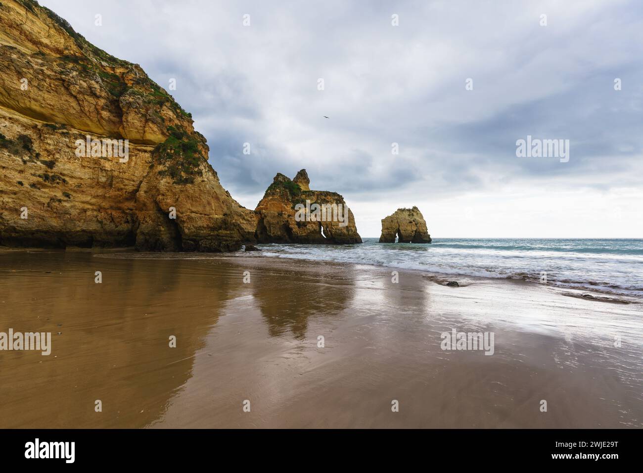 Rugged coastline adorned with natural arches and caves, where turbulent ...