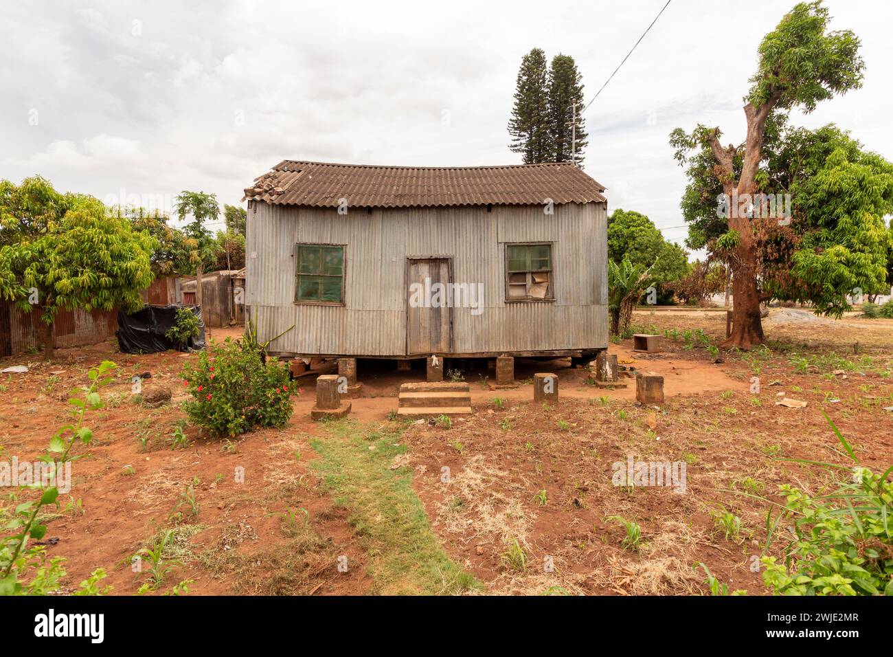 Antique zinc-clad house of precarious construction elevated on stilt ...
