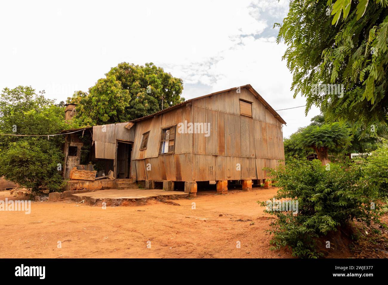 Antique zinc-clad house of precarious construction elevated on stilt ...