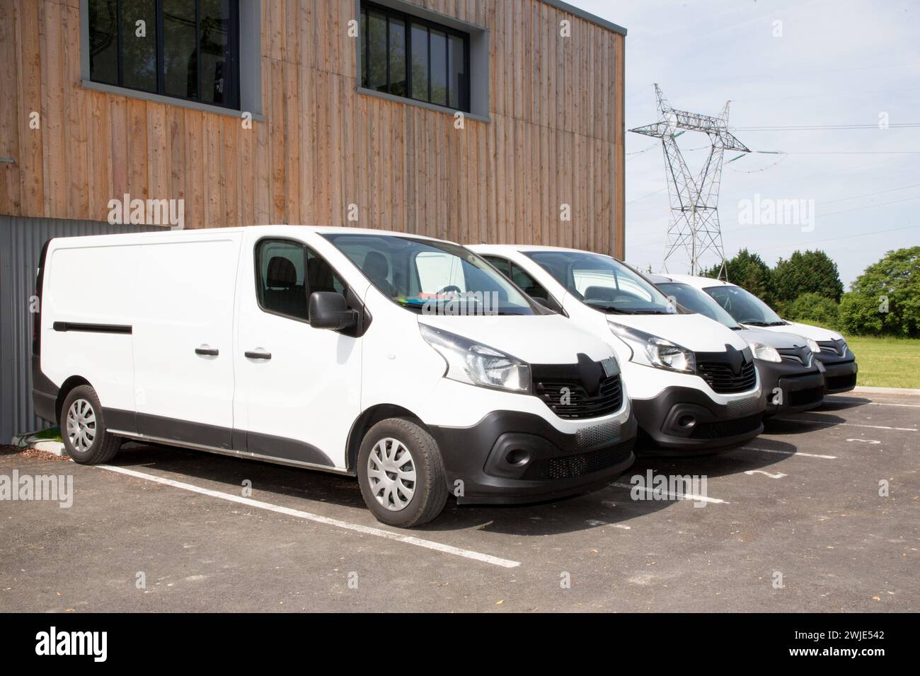 White commercial delivery vans in row to Warehouse Building Stock Photo ...