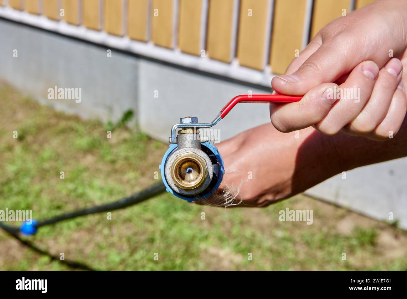 Brass ball valve with an activation lever is connected to polyethylene ...