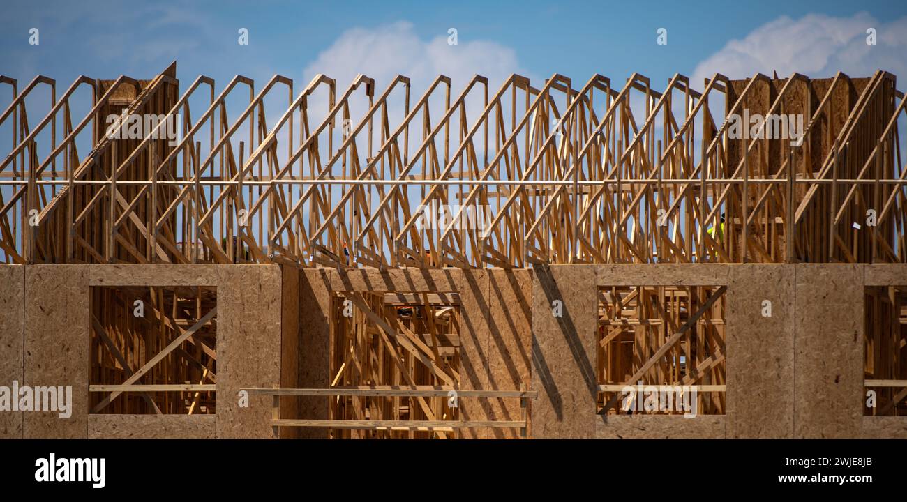 Wooden roof building. Standard timber framed building with roof trusses ...