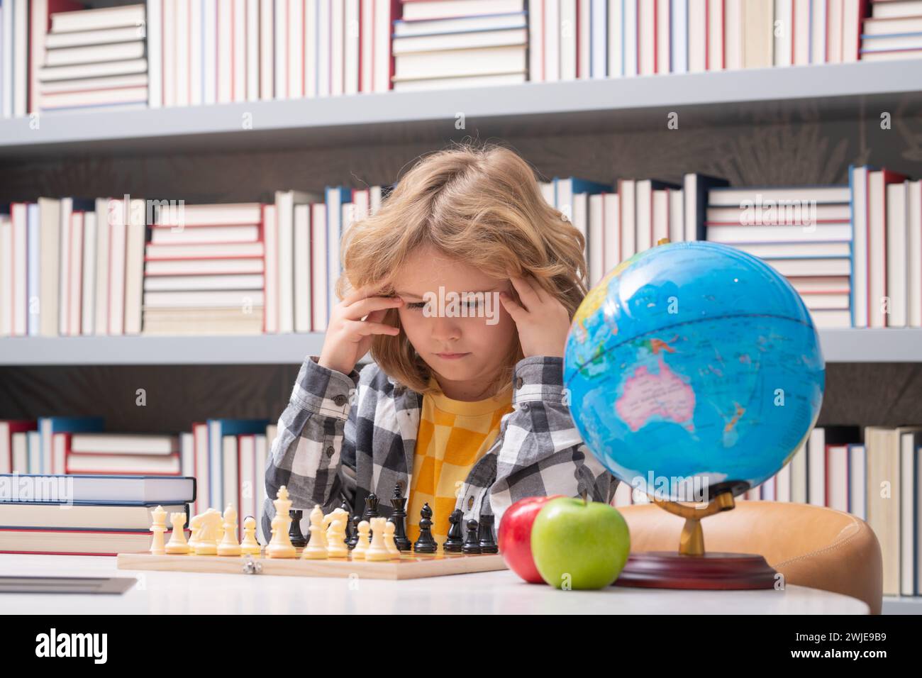Child play chess in classroom at school. Clever concentrated and ...