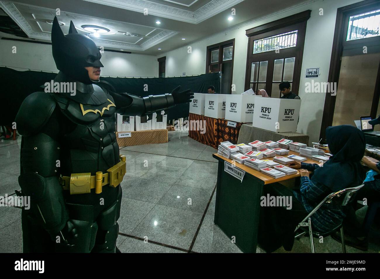 An election official wearing a Batman costume works during Indonesia ...