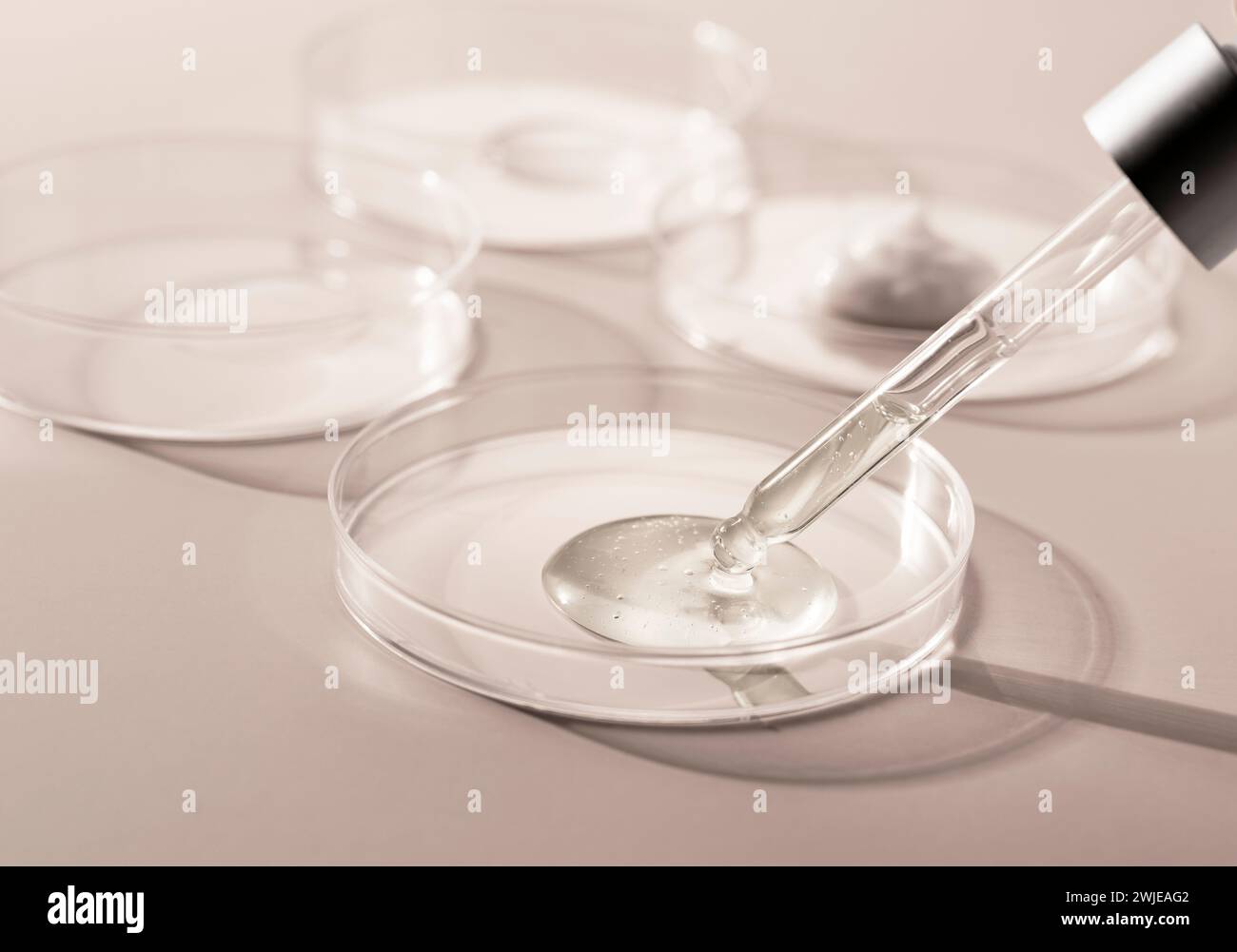 Petri dish and dropper on beige background. Dripping gel Stock Photo ...