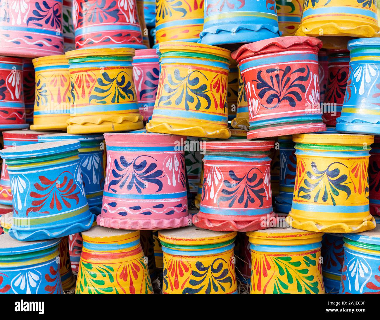 Hand painted vibrant color new clay pots for plants Stock Photo - Alamy