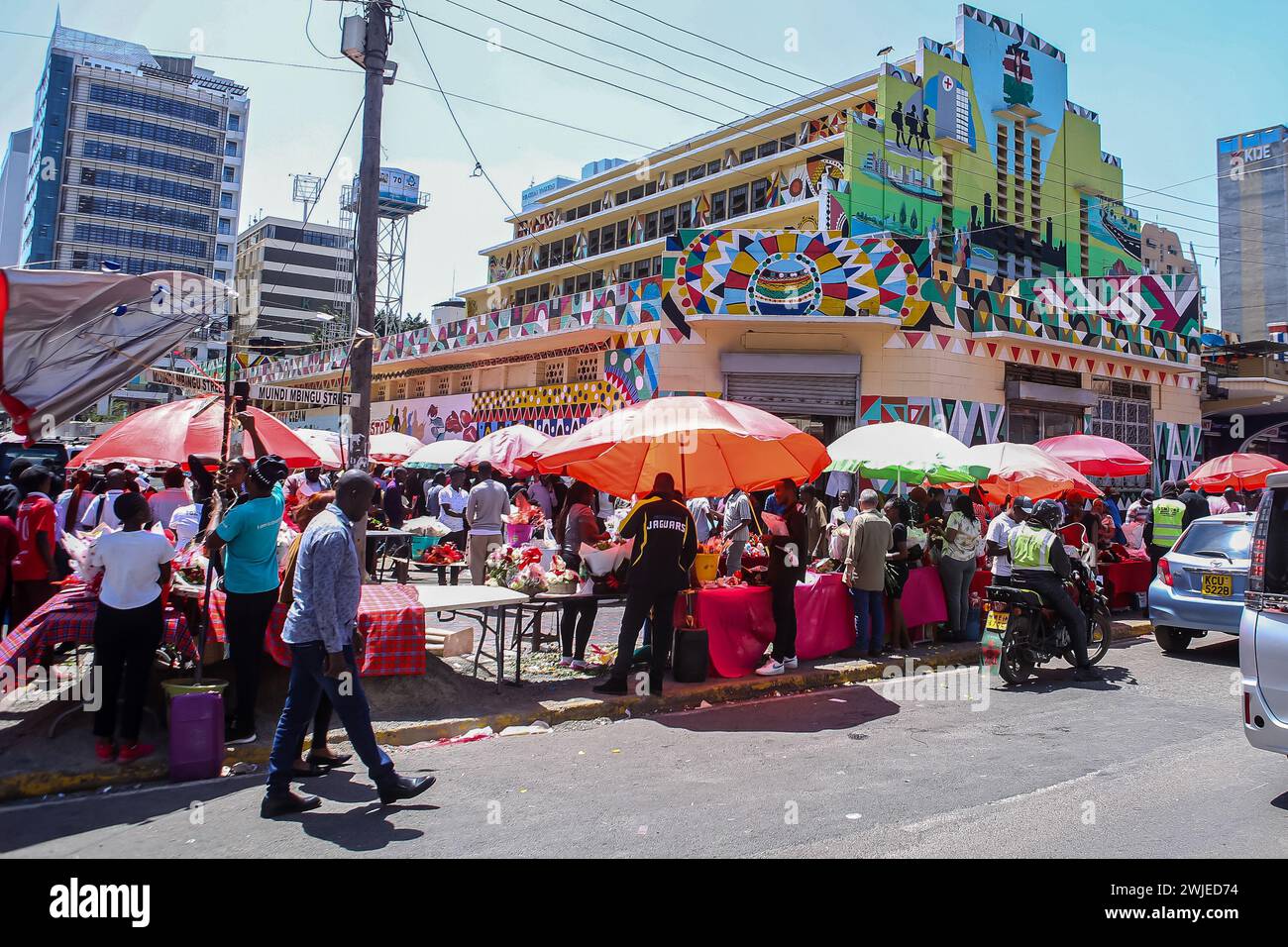 Kenyan florists sell flowers along the Nairobi City Market wall during ...
