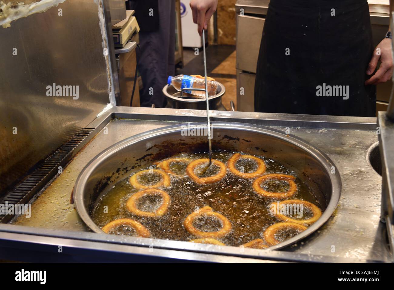 A chef cooks the traditional Halka Tatlisi or Turkish churros in a ...