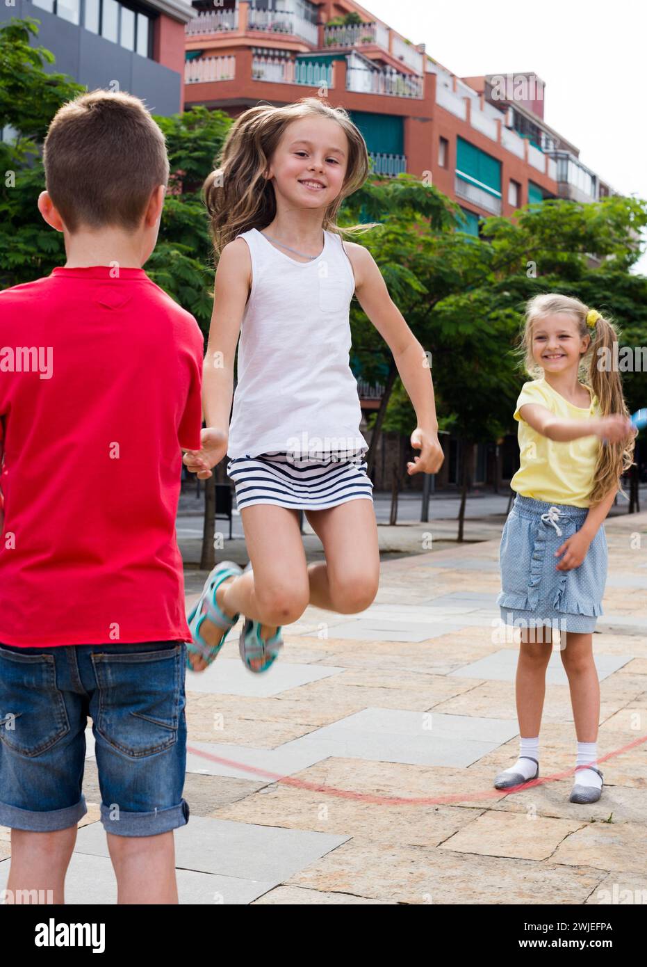 Entertaining children's games. A boy jumps over a rope Stock Photo - Alamy