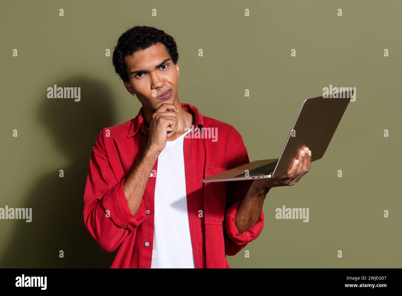 Photo of suspicious uncertain guy cheerful wear red shirt working ...