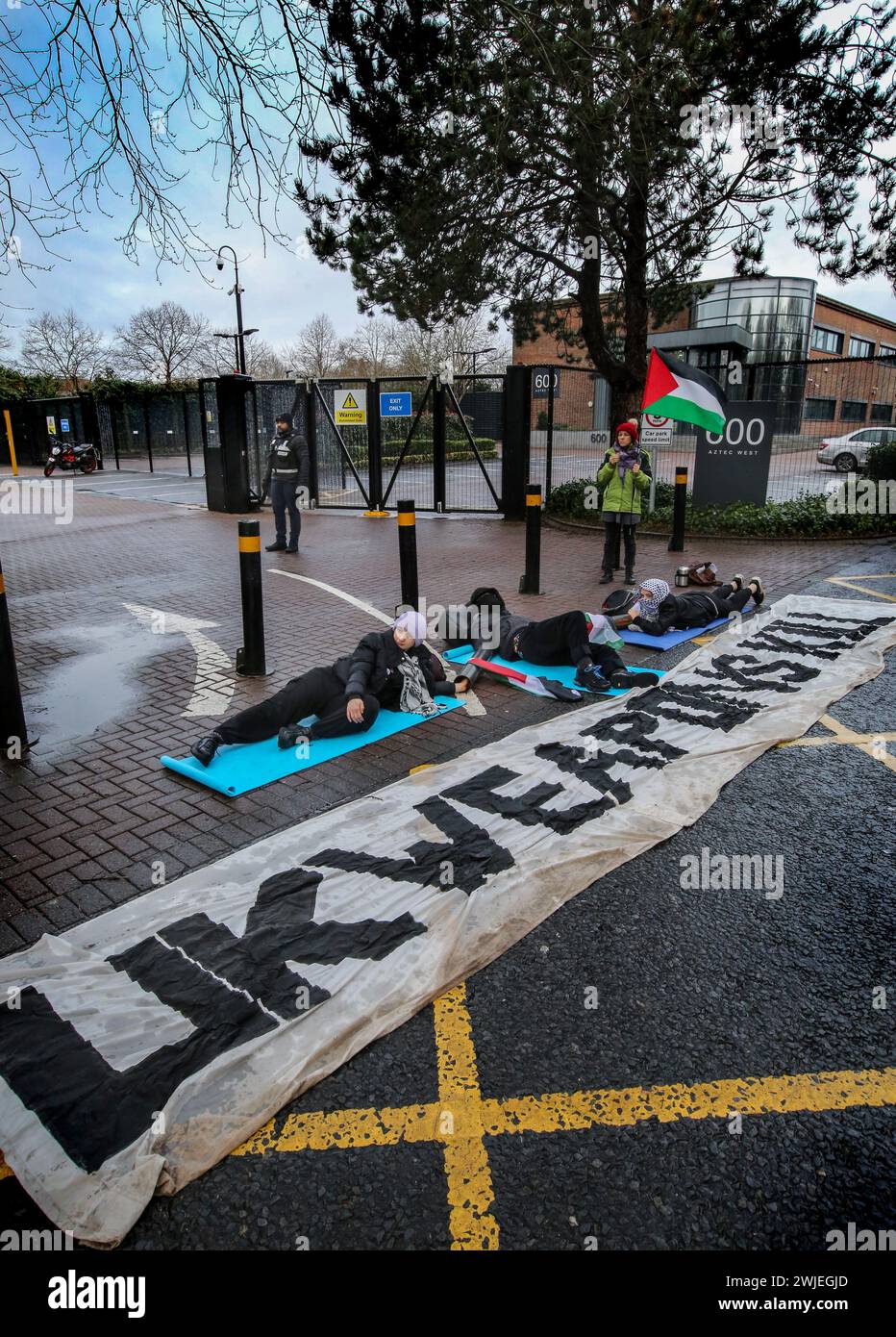 Protesters place themselves in a three-way lock-on, blocking the ...