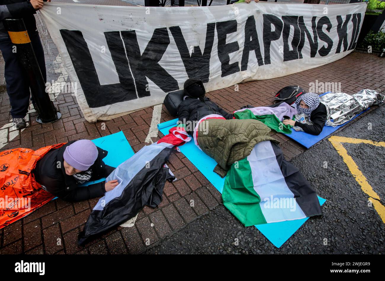Protesters place themselves in a three-way lock-on, blocking the ...