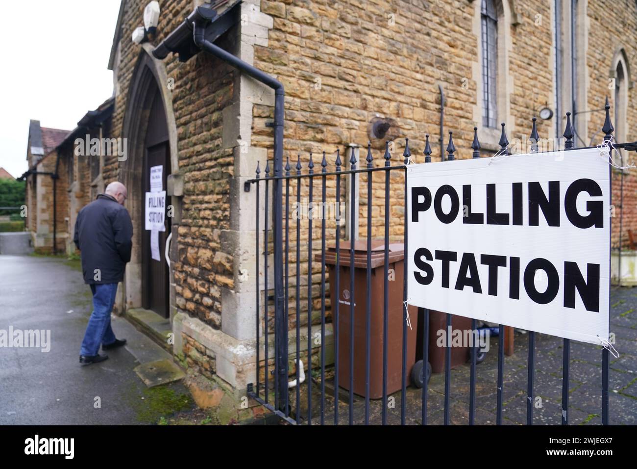 People arrive at St Peter's Church Hall, in Rushden, as voting gets ...