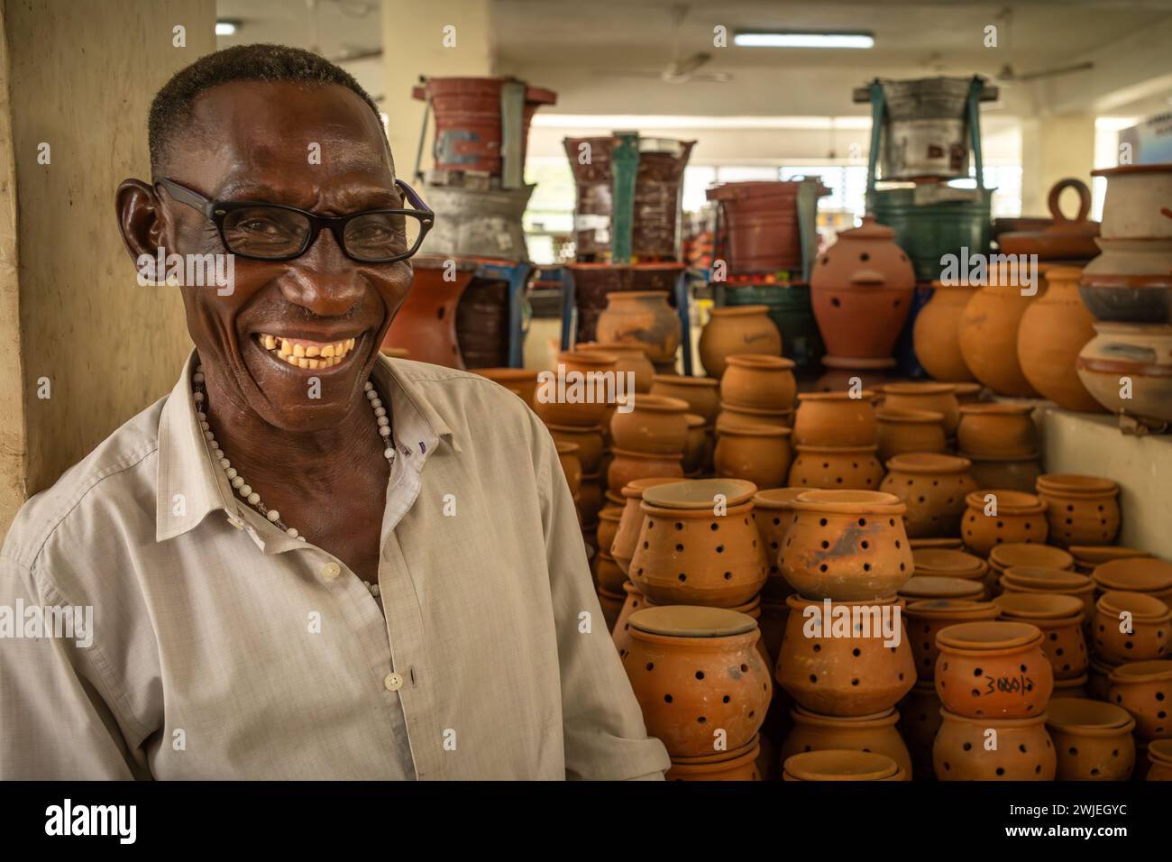 A man selling traditional charcoal powered clay cooking stoves stands ...